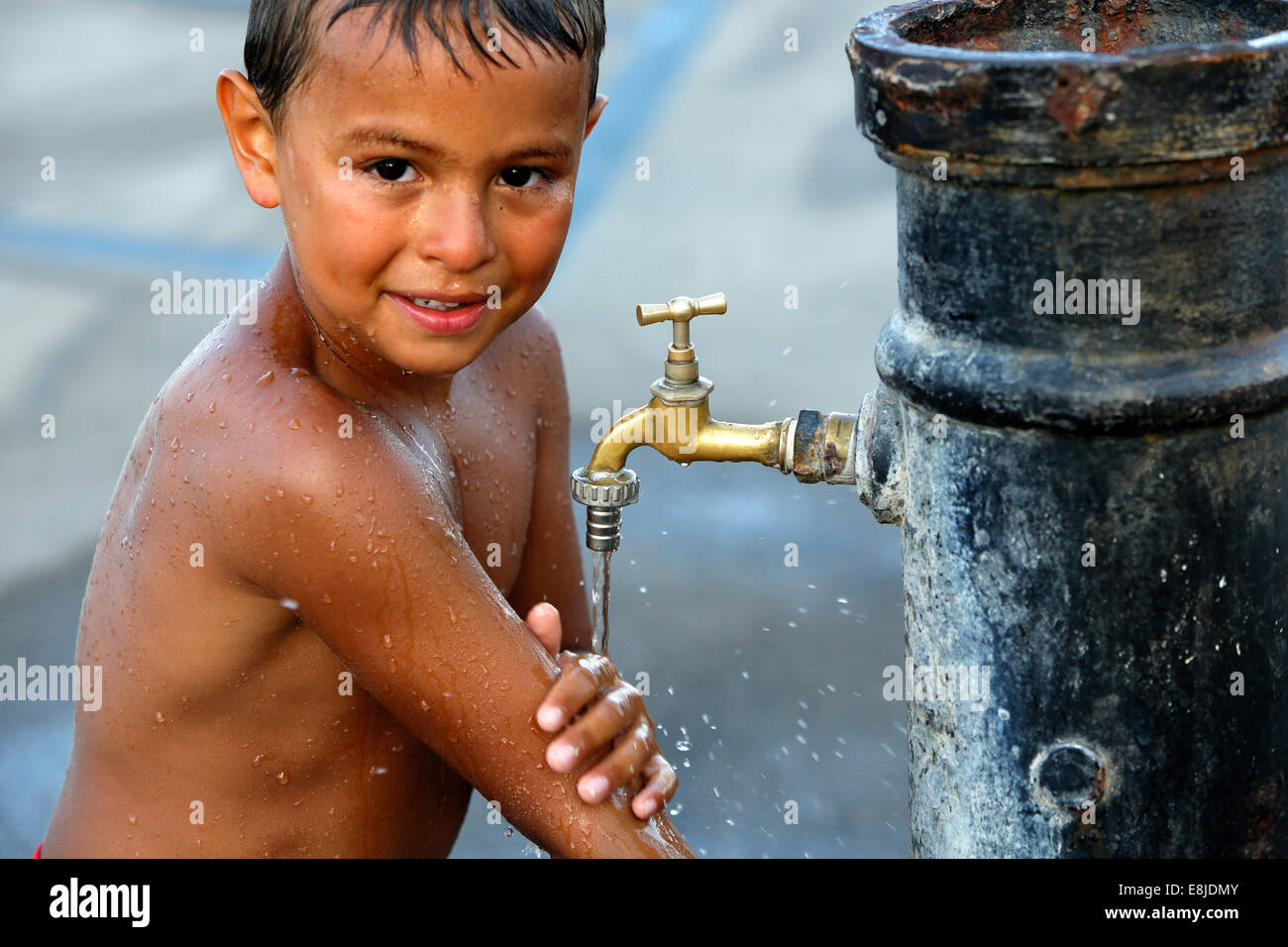 Boy washing at a fountain Stock Photo - Alamy