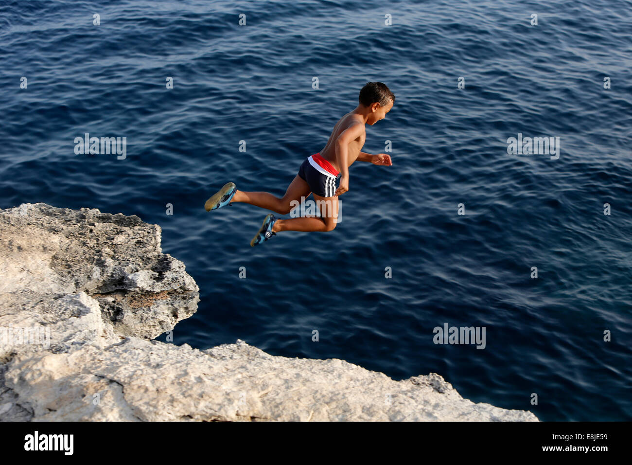 Boy jumping off cliff hi-res stock photography and images - Alamy