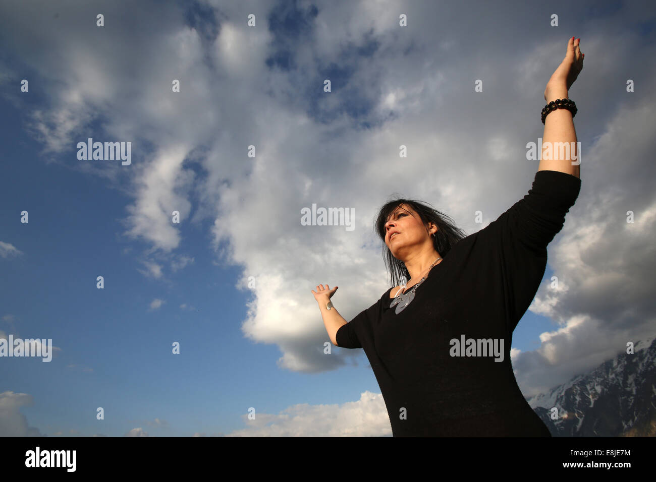 Woman praying outside Stock Photo - Alamy