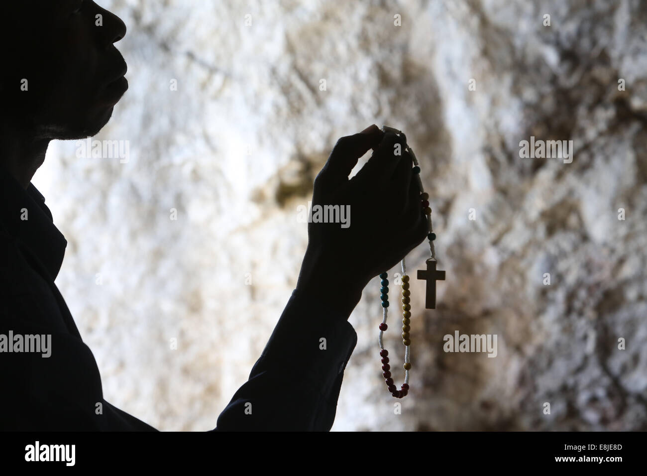 Man praying the rosary Stock Photo - Alamy