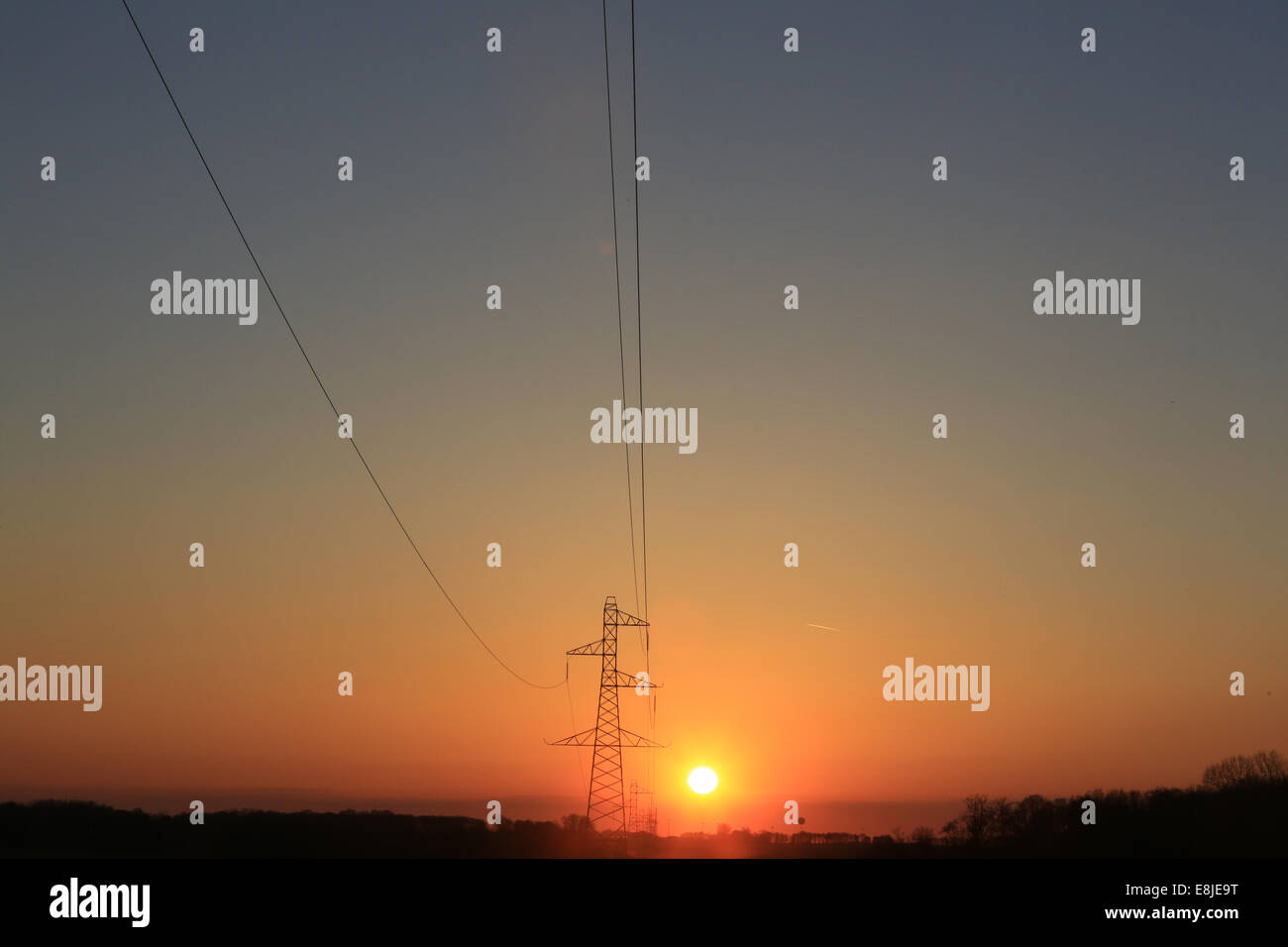 Electricity pylons sunset Stock Photo - Alamy