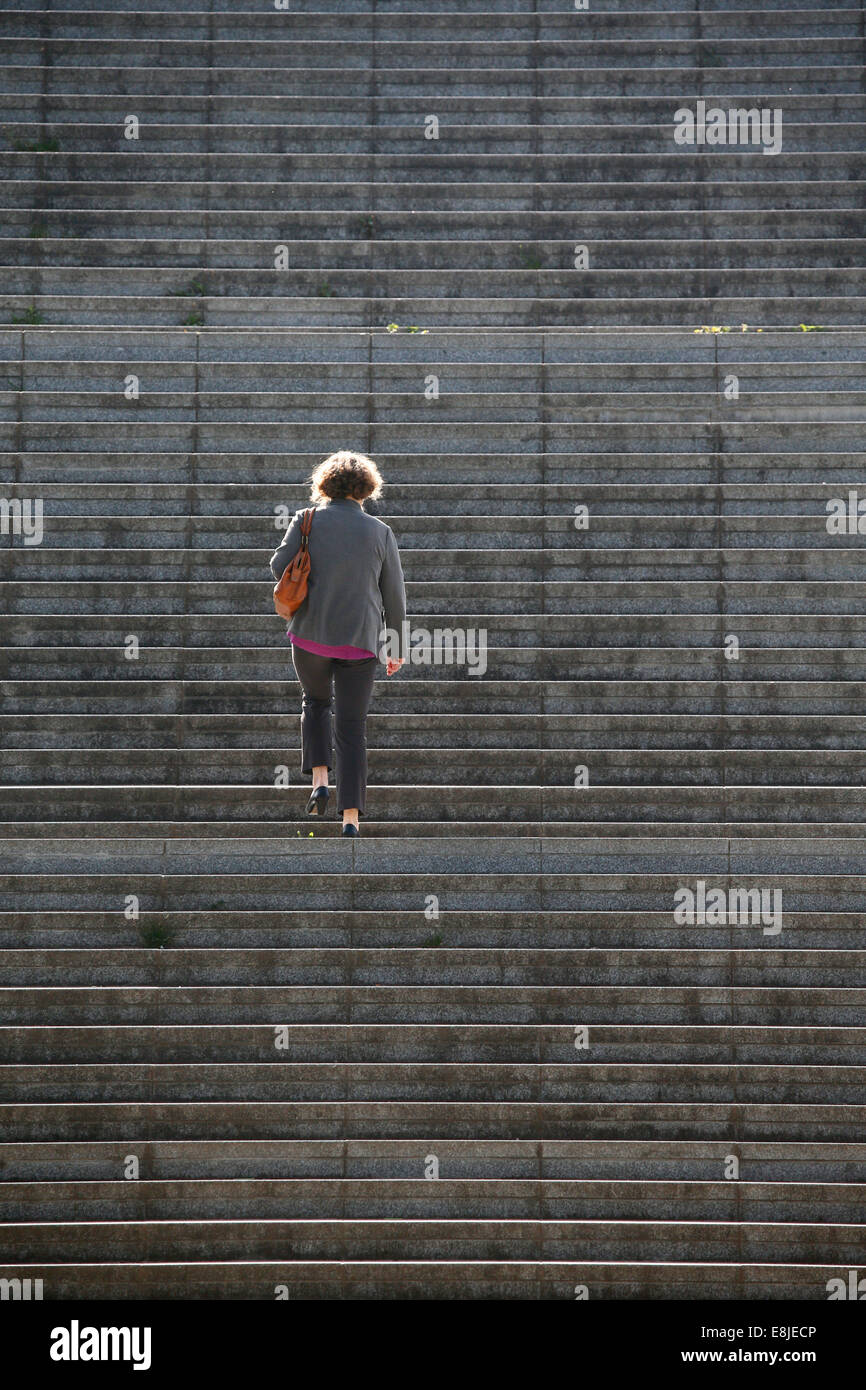Man walking up a staircase Stock Photo - Alamy