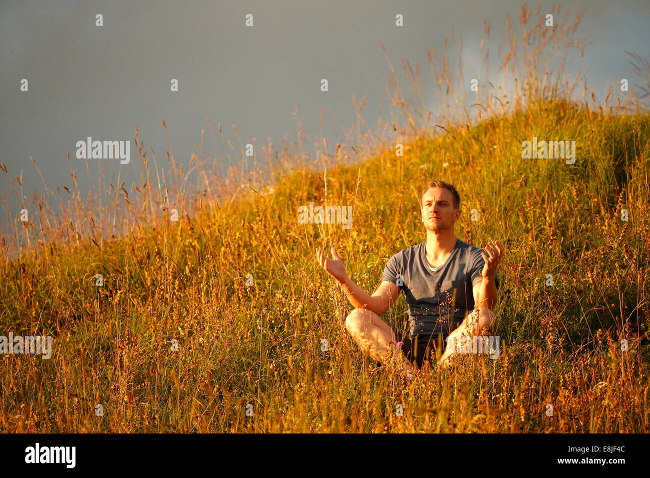 Man praying outside Stock Photo - Alamy