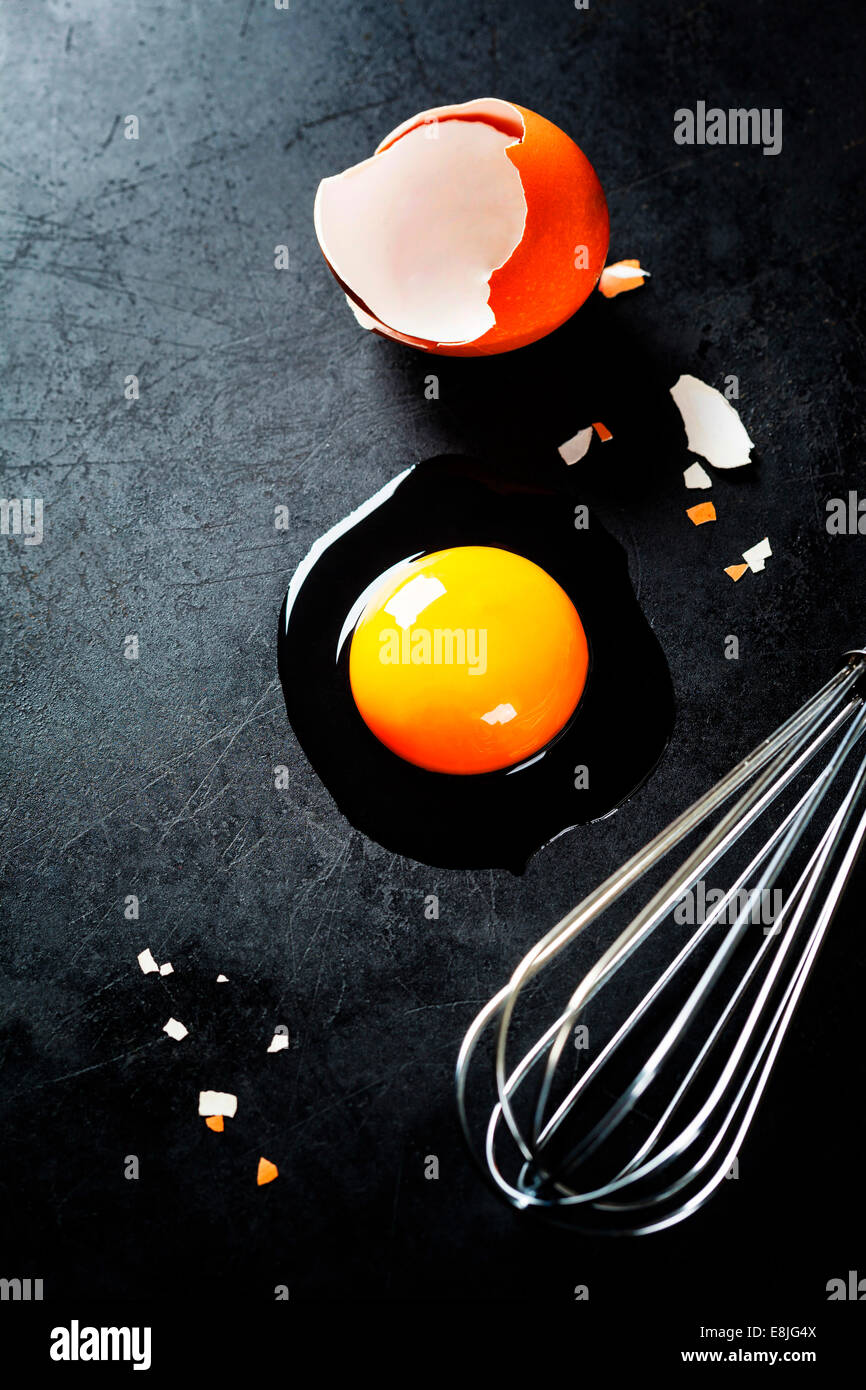 Raw egg on dark background Stock Photo - Alamy