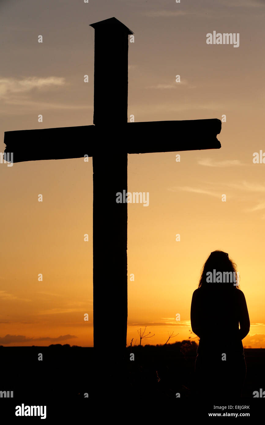 Woman praying at sunset Stock Photo - Alamy