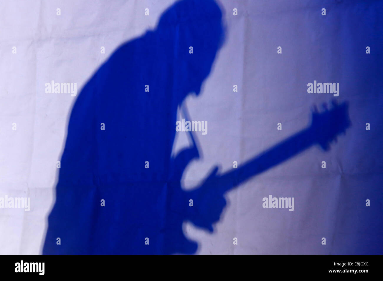 Guitar player's shadow Stock Photo - Alamy