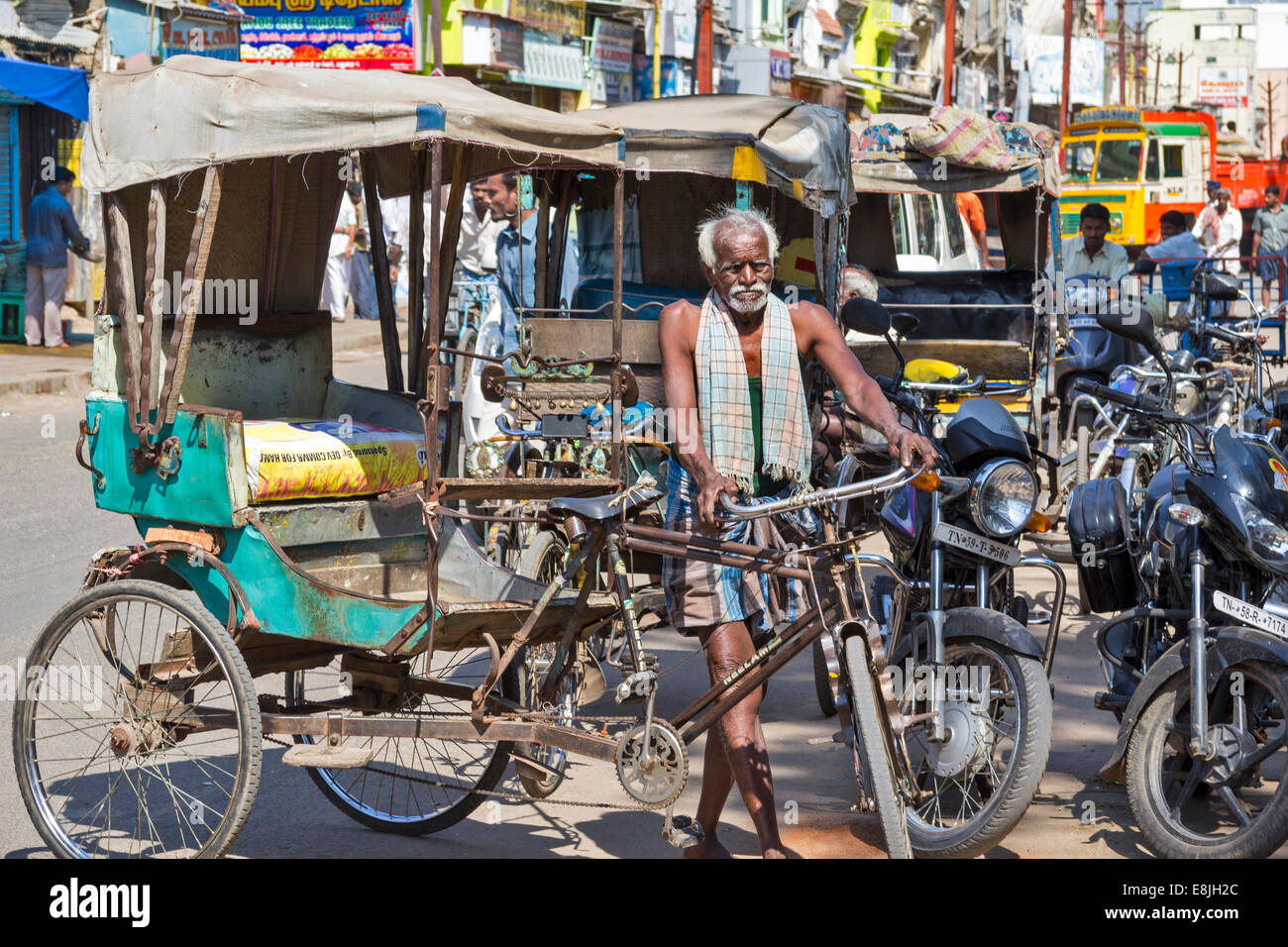 RICKSHAW DRIVER AND AN OLD RICKSHAW AMONG THE MODERN MACHINES IN THE ...
