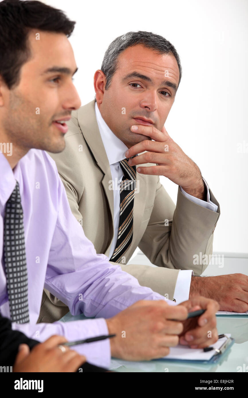 Two men sat on interview panel Stock Photo - Alamy