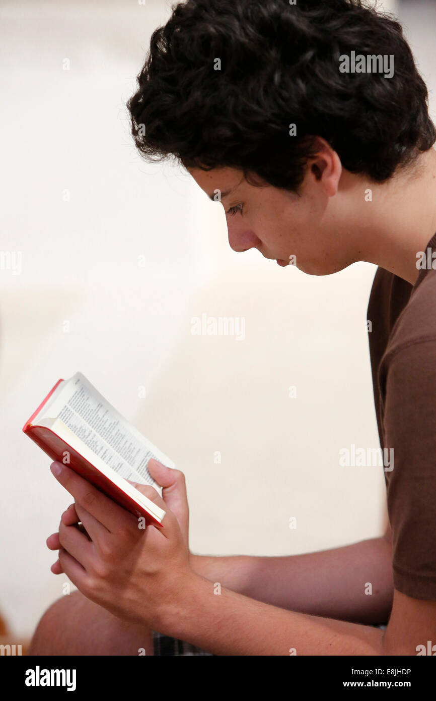 Teenager reading the Bible in a church Stock Photo - Alamy