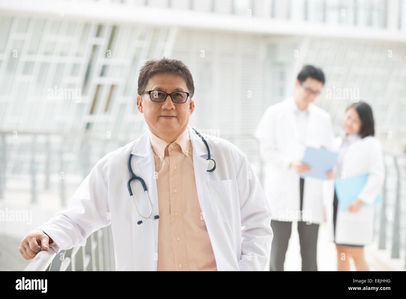 Asian medical team of doctors standing inside hospital building Stock ...