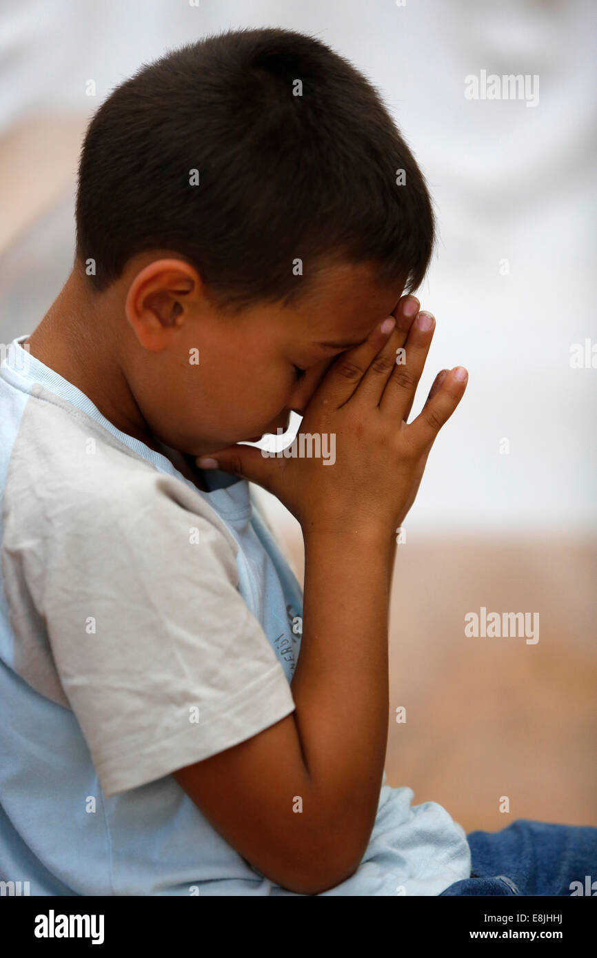 Boy praying in a church Stock Photo - Alamy