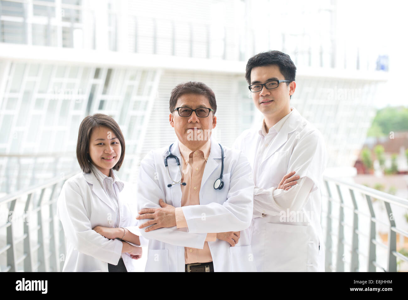 Asian medical team of doctors standing inside hospital building Stock ...