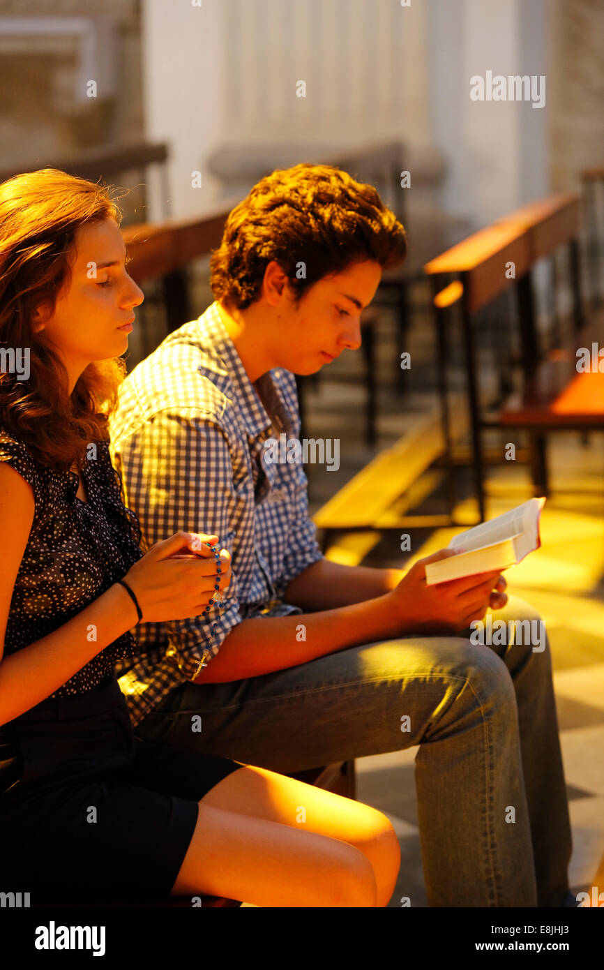 Teenagers praying and reading the Bible in a church Stock Photo - Alamy