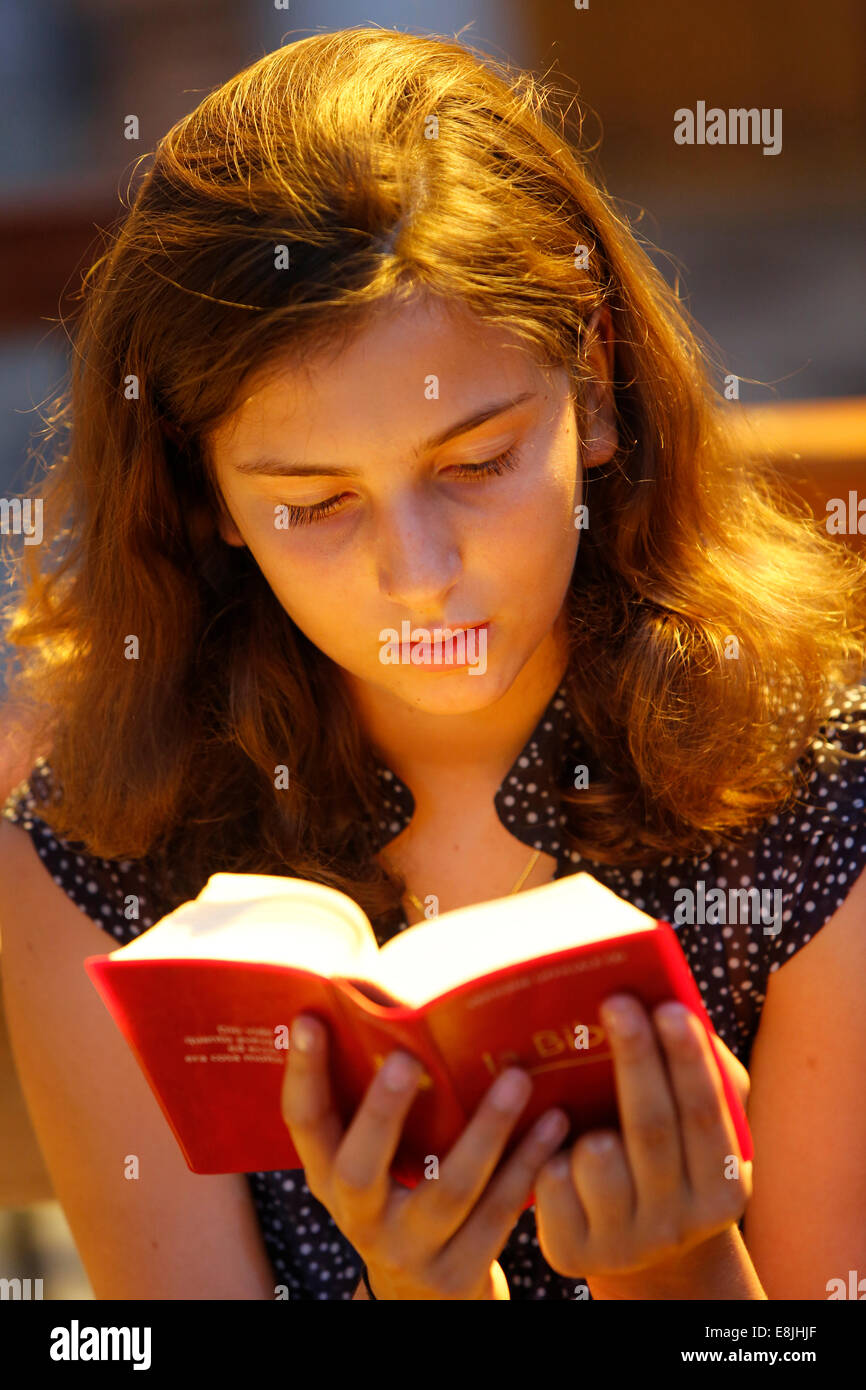 Teenager reading the Bible in a church Stock Photo - Alamy