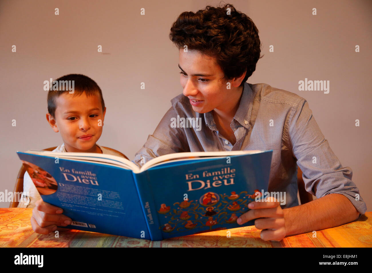 Brothers reading a Christian book Stock Photo - Alamy