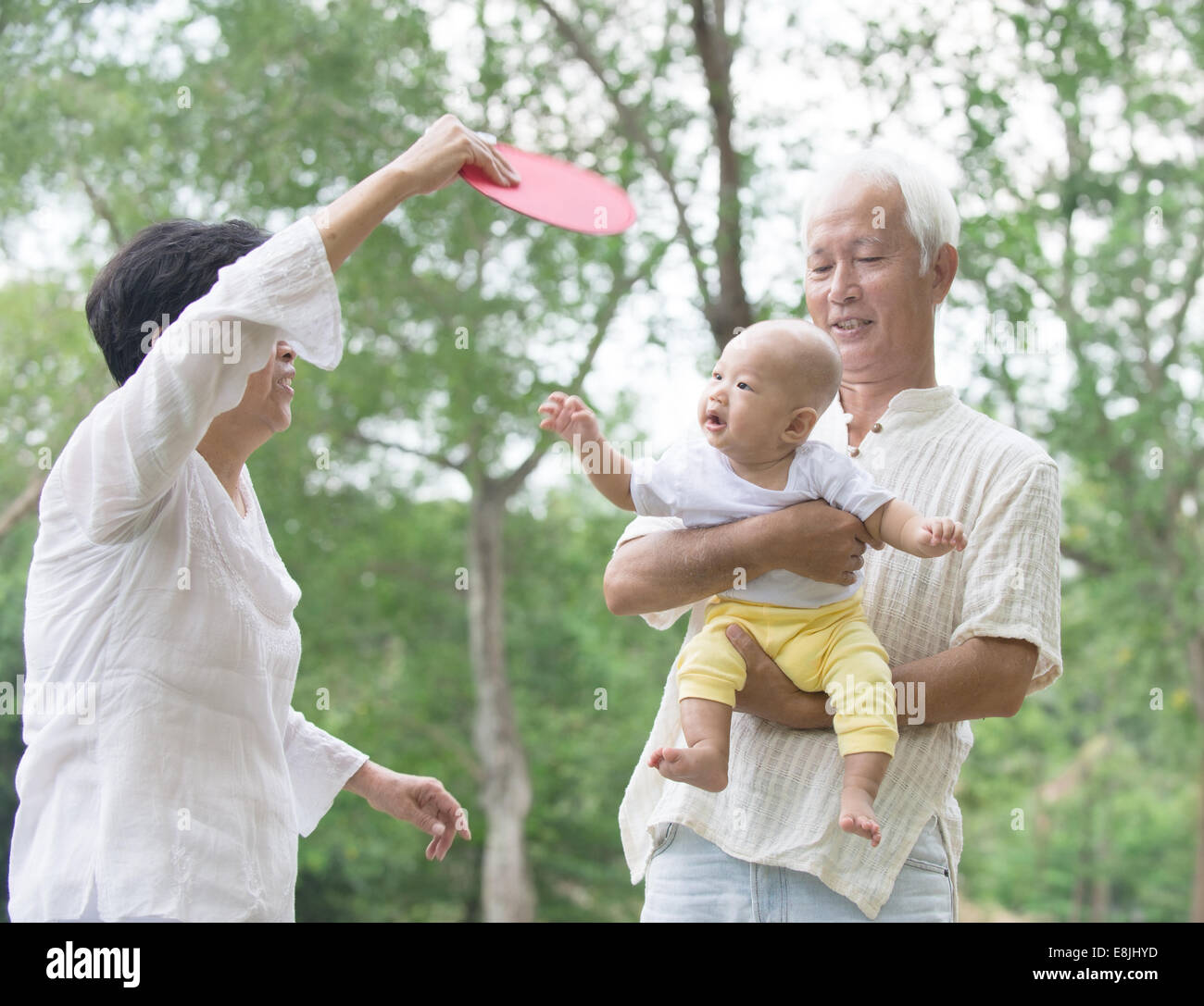 asian grandparents playing with baby grandson at outdoor Stock Photo ...