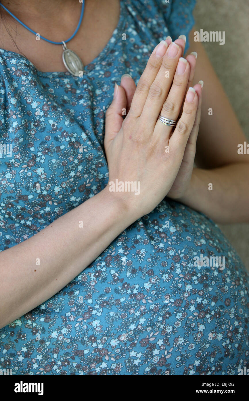 Pregnant woman praying Stock Photo - Alamy