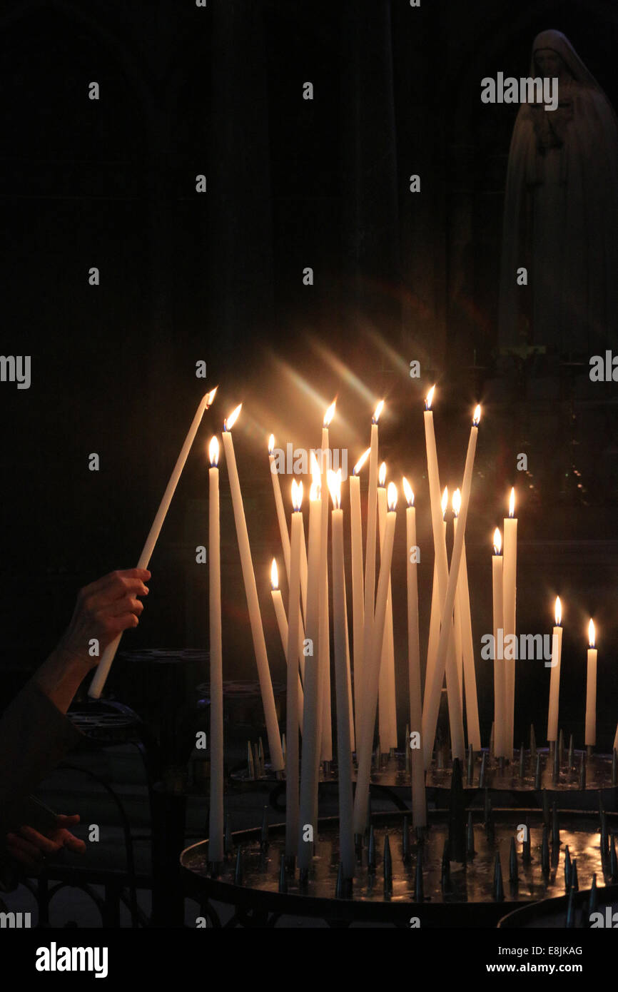 Woman lighting a candle Stock Photo - Alamy