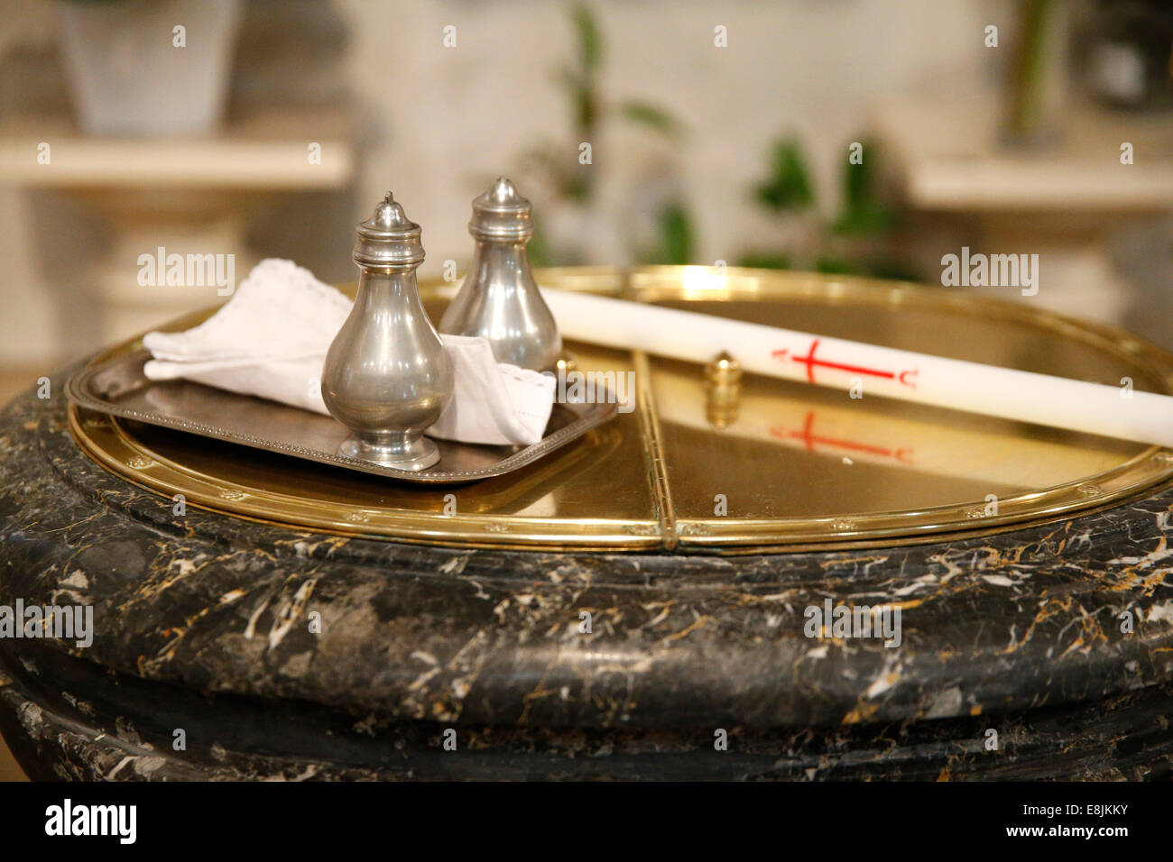 Baptistery, altar candle and chrism for the baptism Stock Photo - Alamy