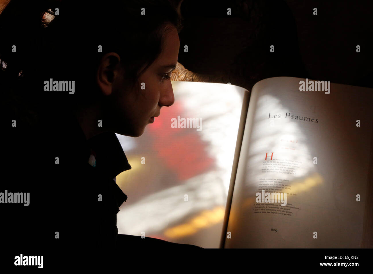 Girl looking at a bible Stock Photo - Alamy