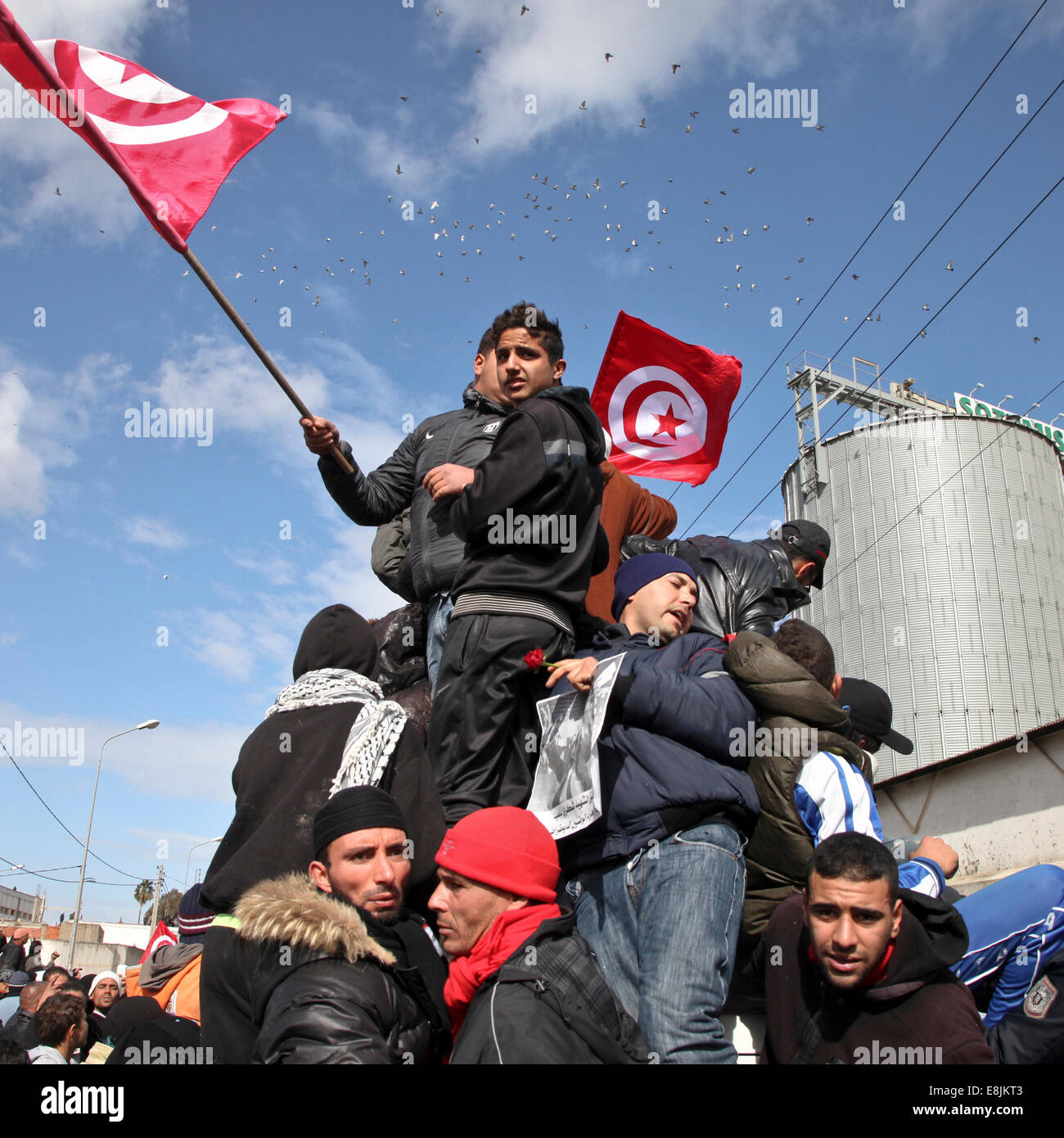 Tunisians attending the funeral of murdered trade-unionist Chokri ...