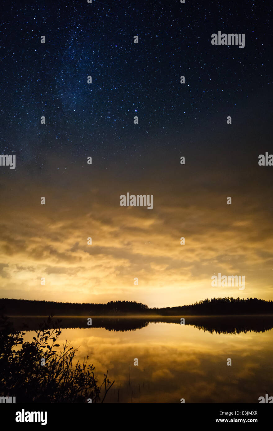 Stars over the sunset scene in Finland. Reflections of the forest ...