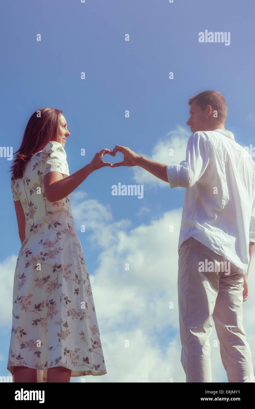 a couple forming a heart with their hands Stock Photo - Alamy