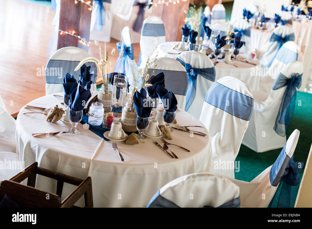 Banquet hall decorated for wedding in white and blue Stock Photo - Alamy