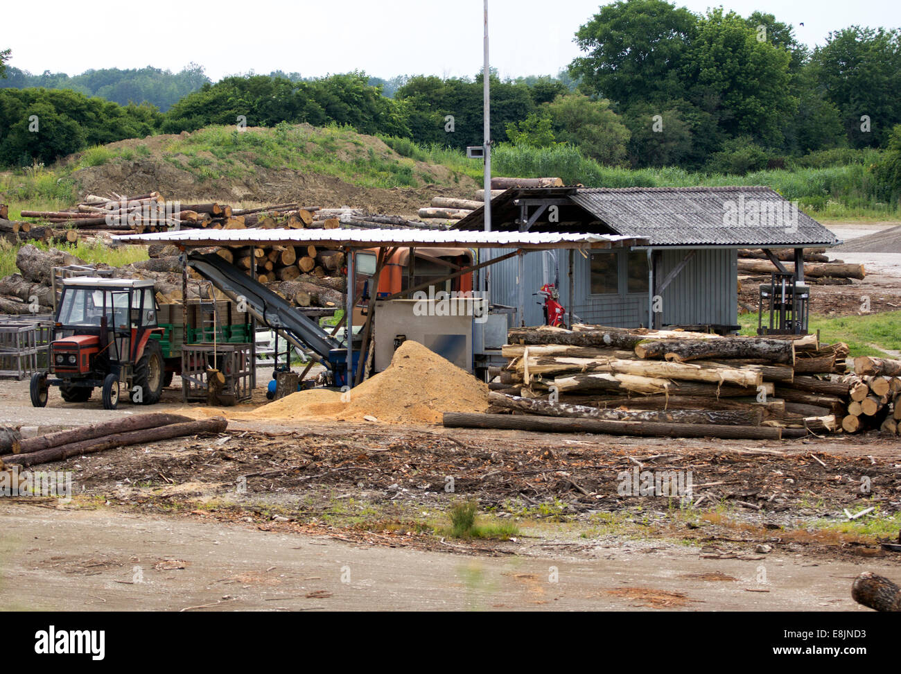 Small wood mill station with tractor Stock Photo - Alamy