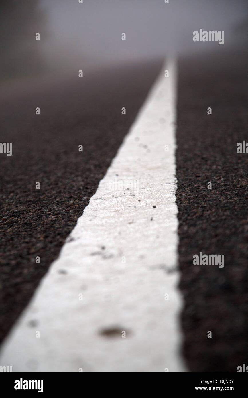 center stripe Asphalt road in an autumn fog Stock Photo - Alamy