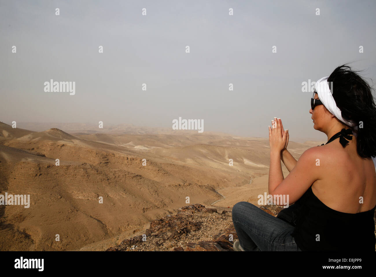 Pilgrimage in Holy Land. Woman praying in Judean desert Stock Photo - Alamy