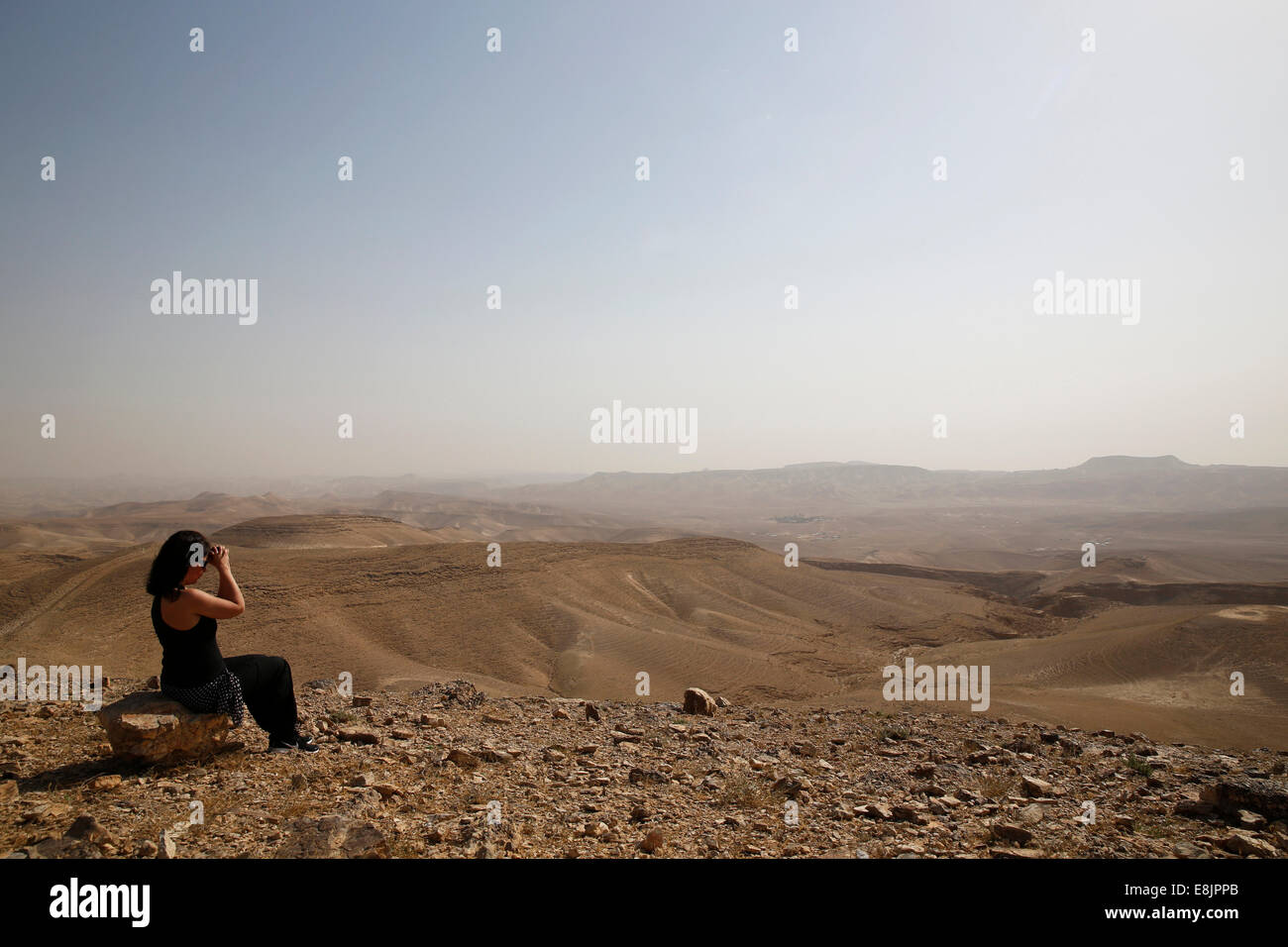 Pilgrimage in Holy Land. Woman praying in Judean desert Stock Photo - Alamy