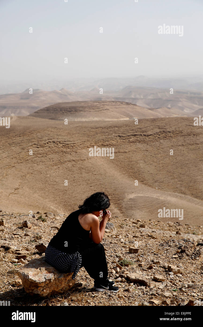Pilgrimage in Holy Land. Woman praying in Judean desert Stock Photo - Alamy