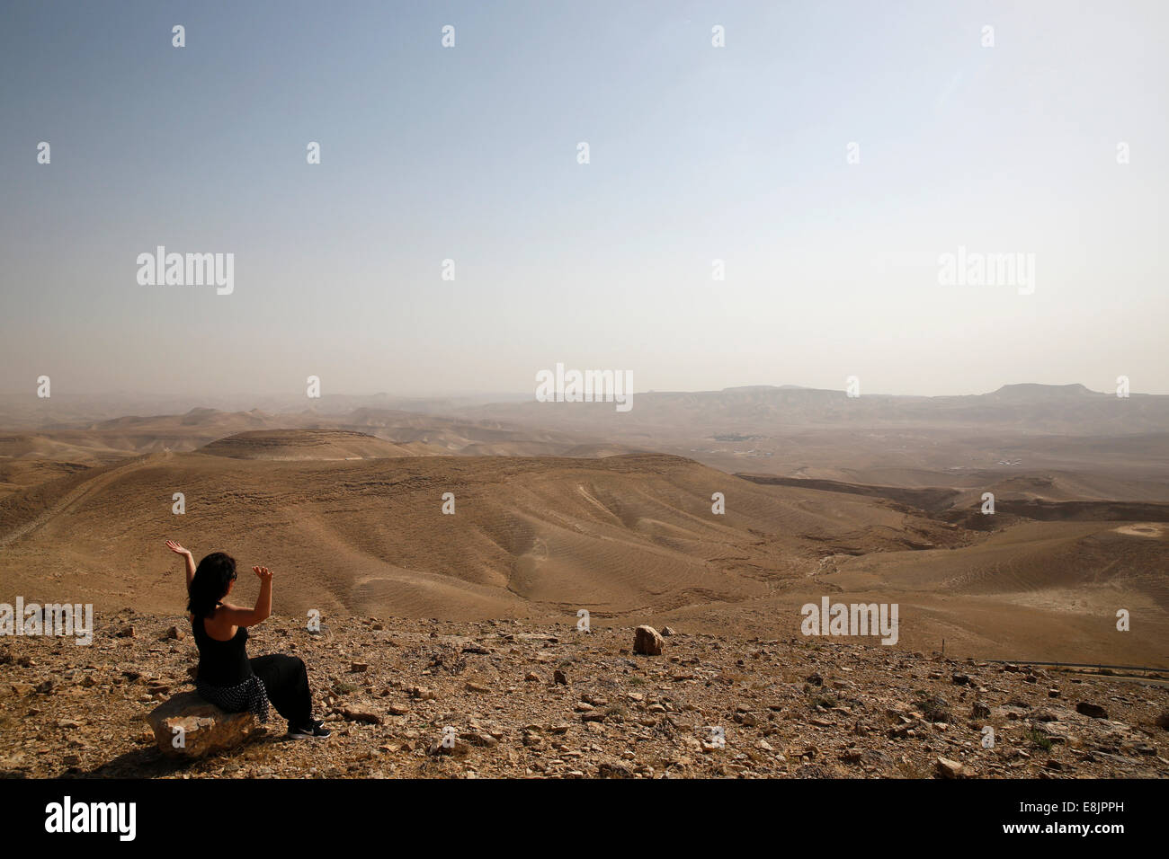 Pilgrimage in Holy Land. Woman praying in Judean desert Stock Photo - Alamy