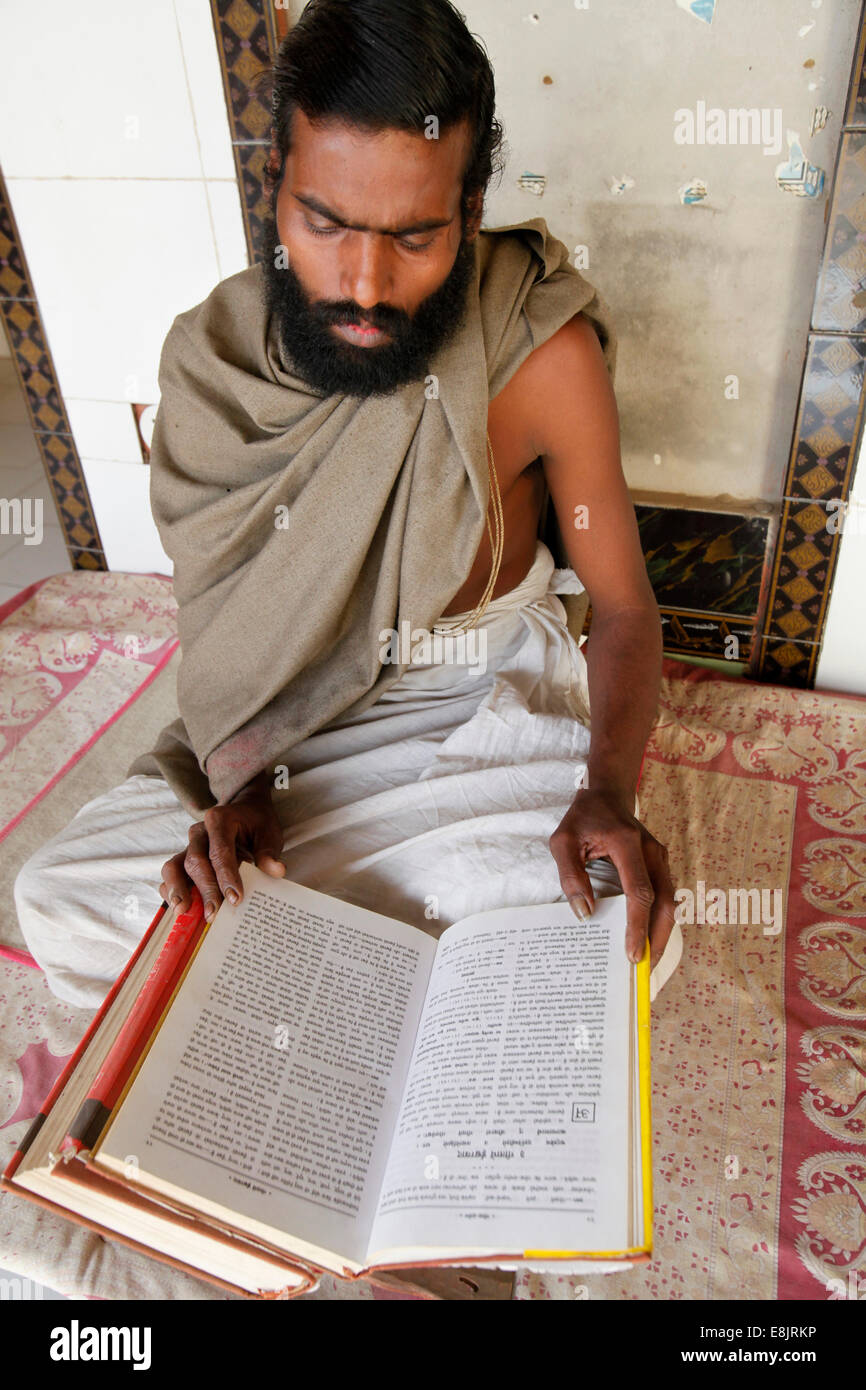 Temple priest reading the Bhagavad Gita. The temple is located on the ...