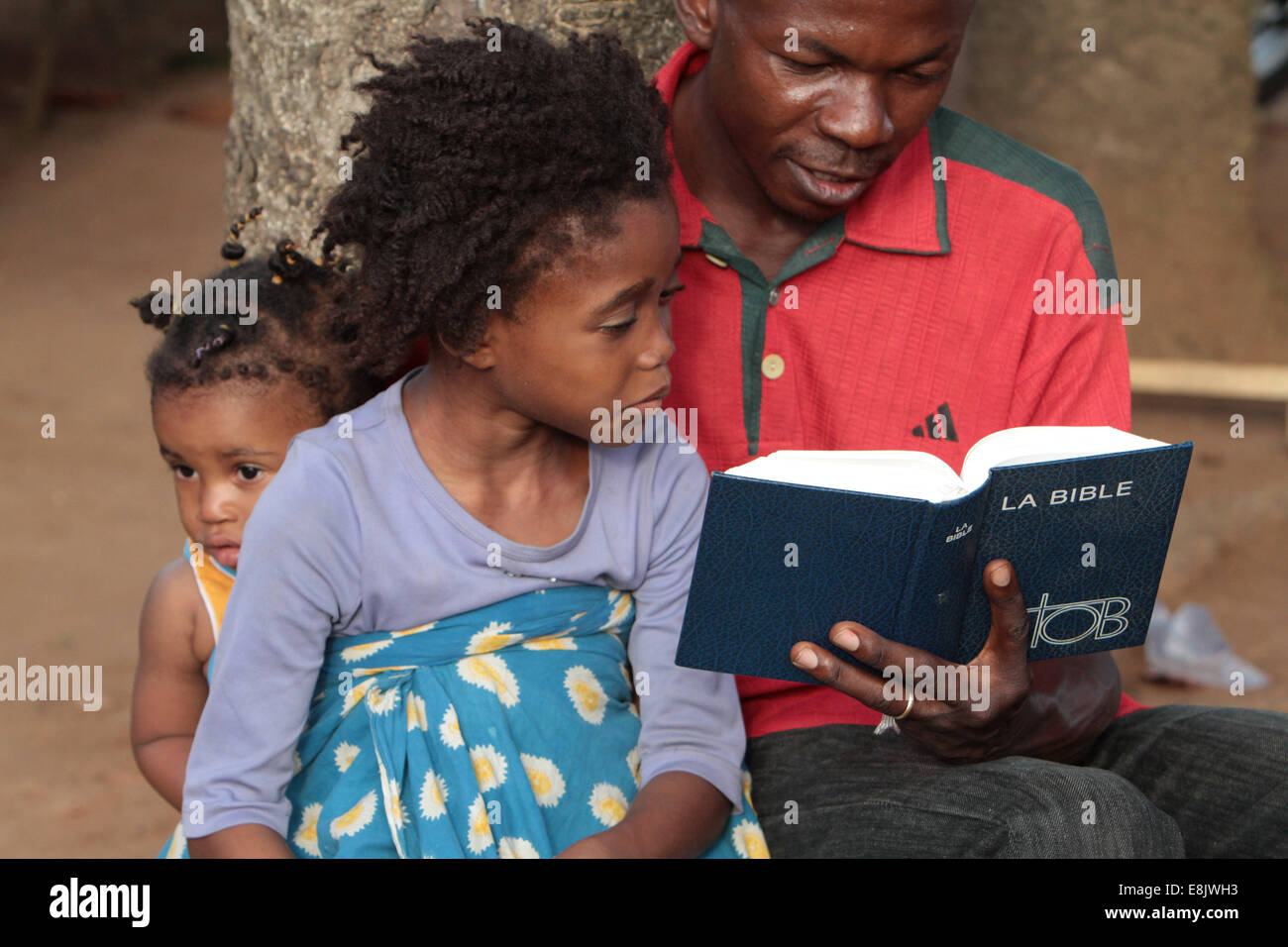 African father reading the Bible Stock Photo - Alamy
