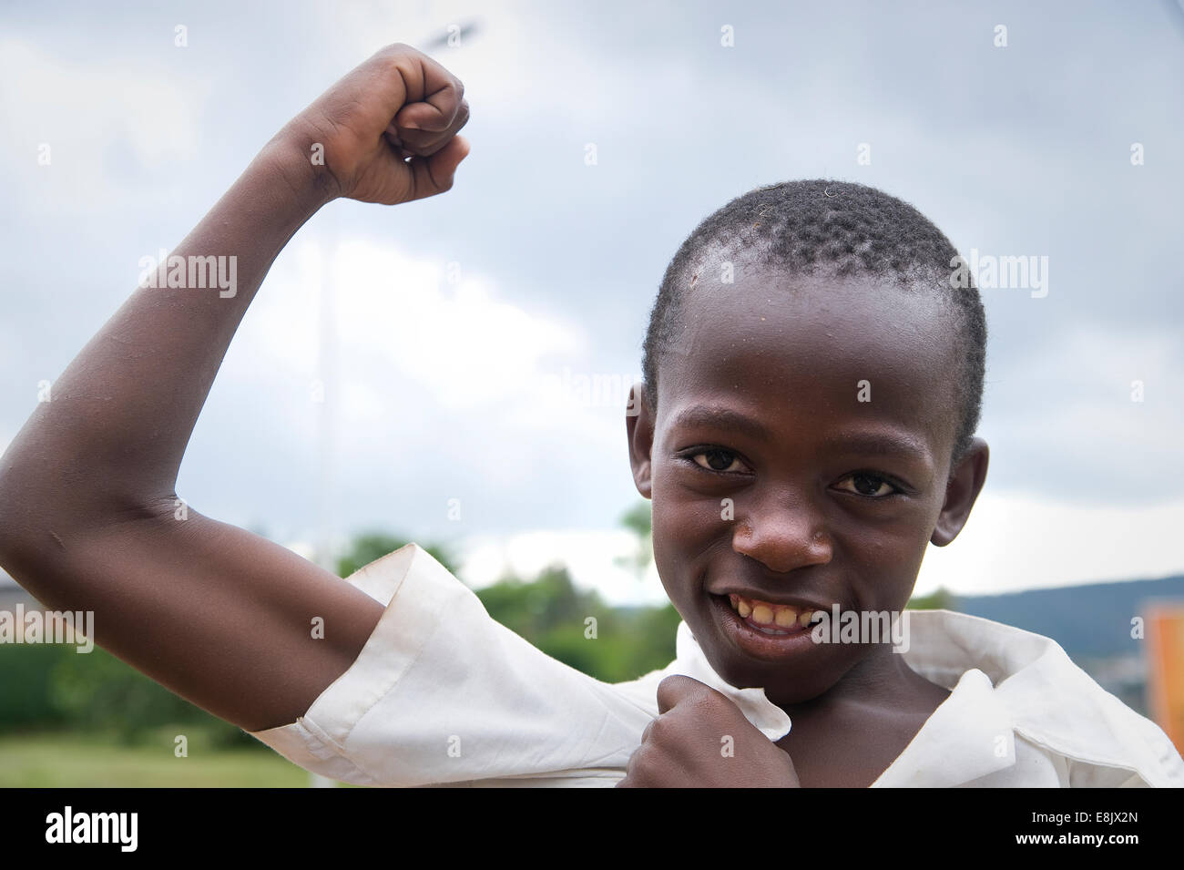 Boy showing off his muscles hi-res stock photography and images - Alamy
