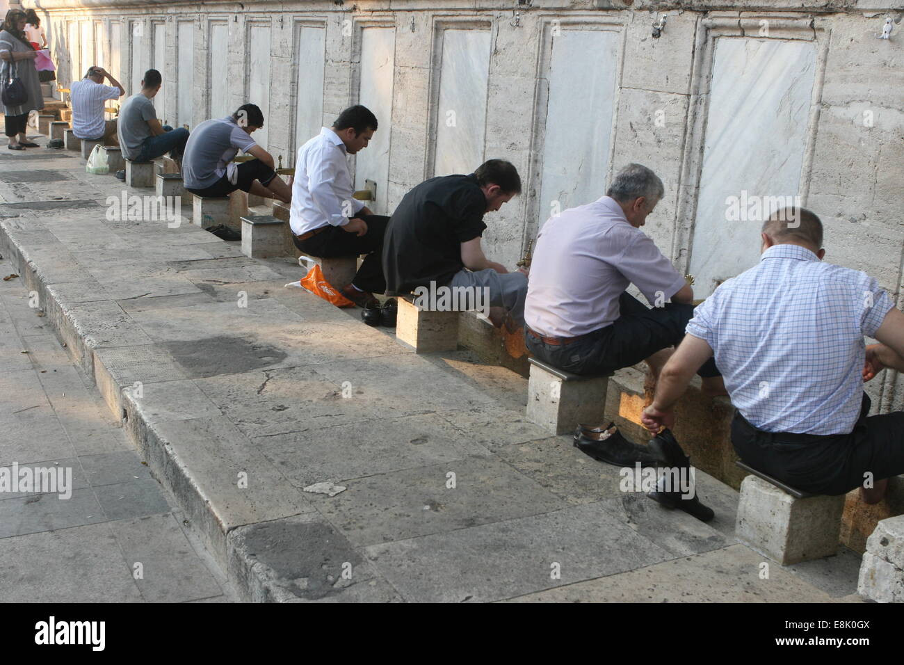 Worshippers preparing for prayers, washing feet outside mosque Stock ...