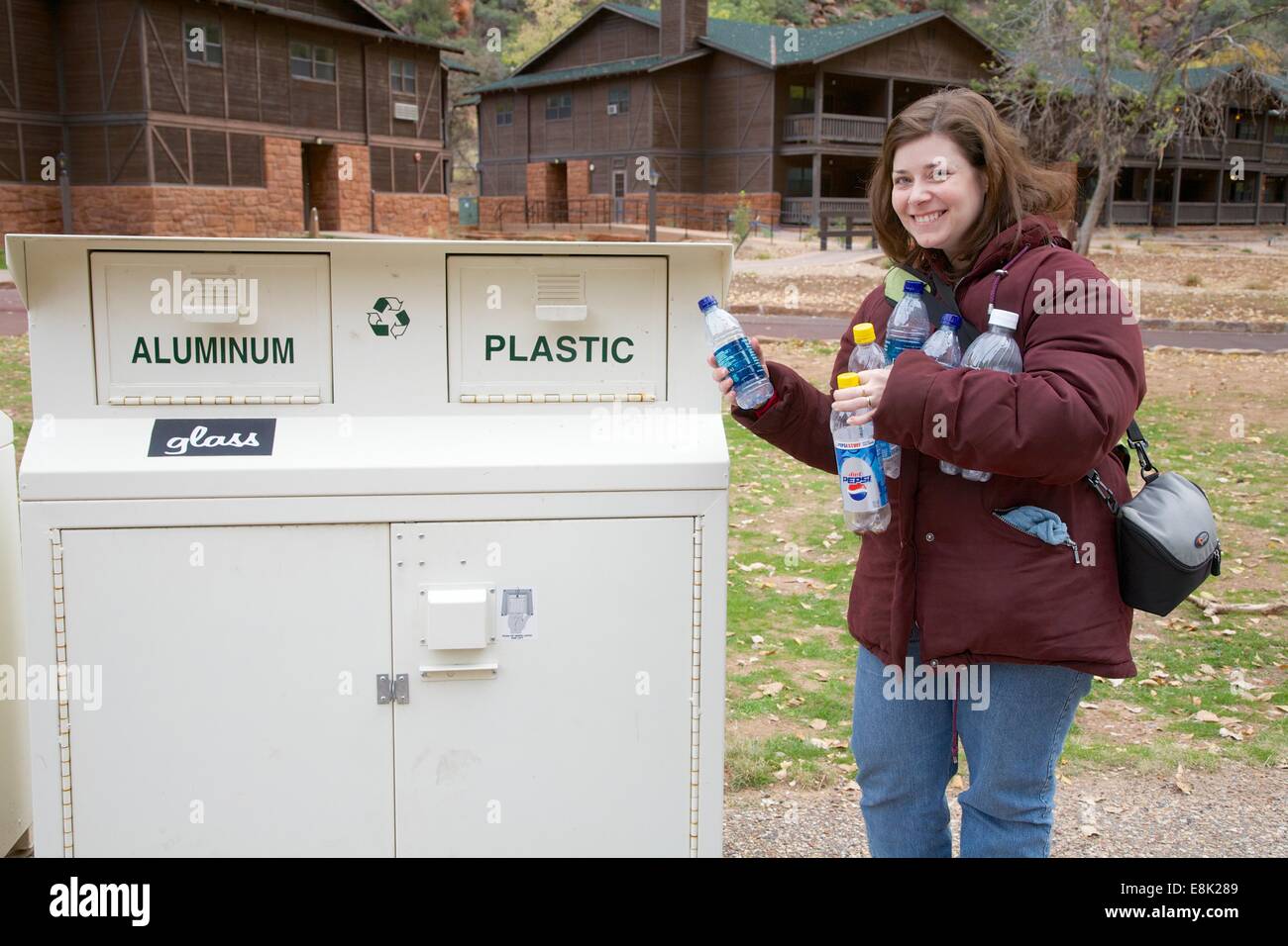 Young woman preparing to put plastic bottles in recycle bin Stock Photo ...