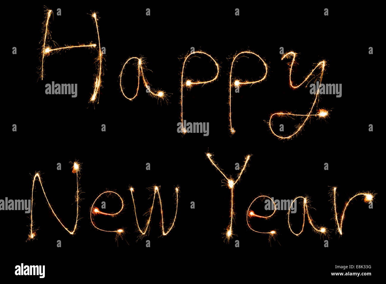 burning sparkler stick and writing happy new year sparkling words on ...