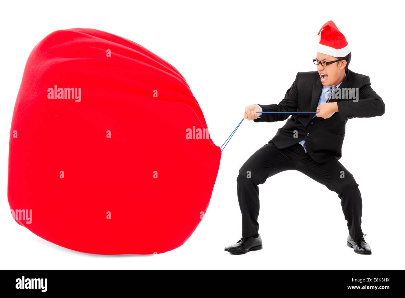 business man carrying a heavy gift sack with christmas hat. isolated on ...