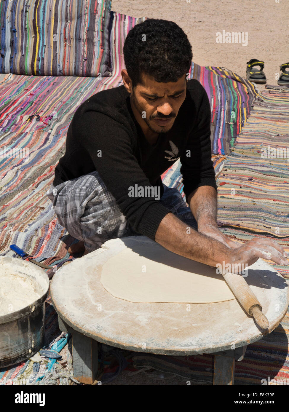 Egypt, Sinai,Bedouin Desert Camp, man rolling out traditional fatir ...