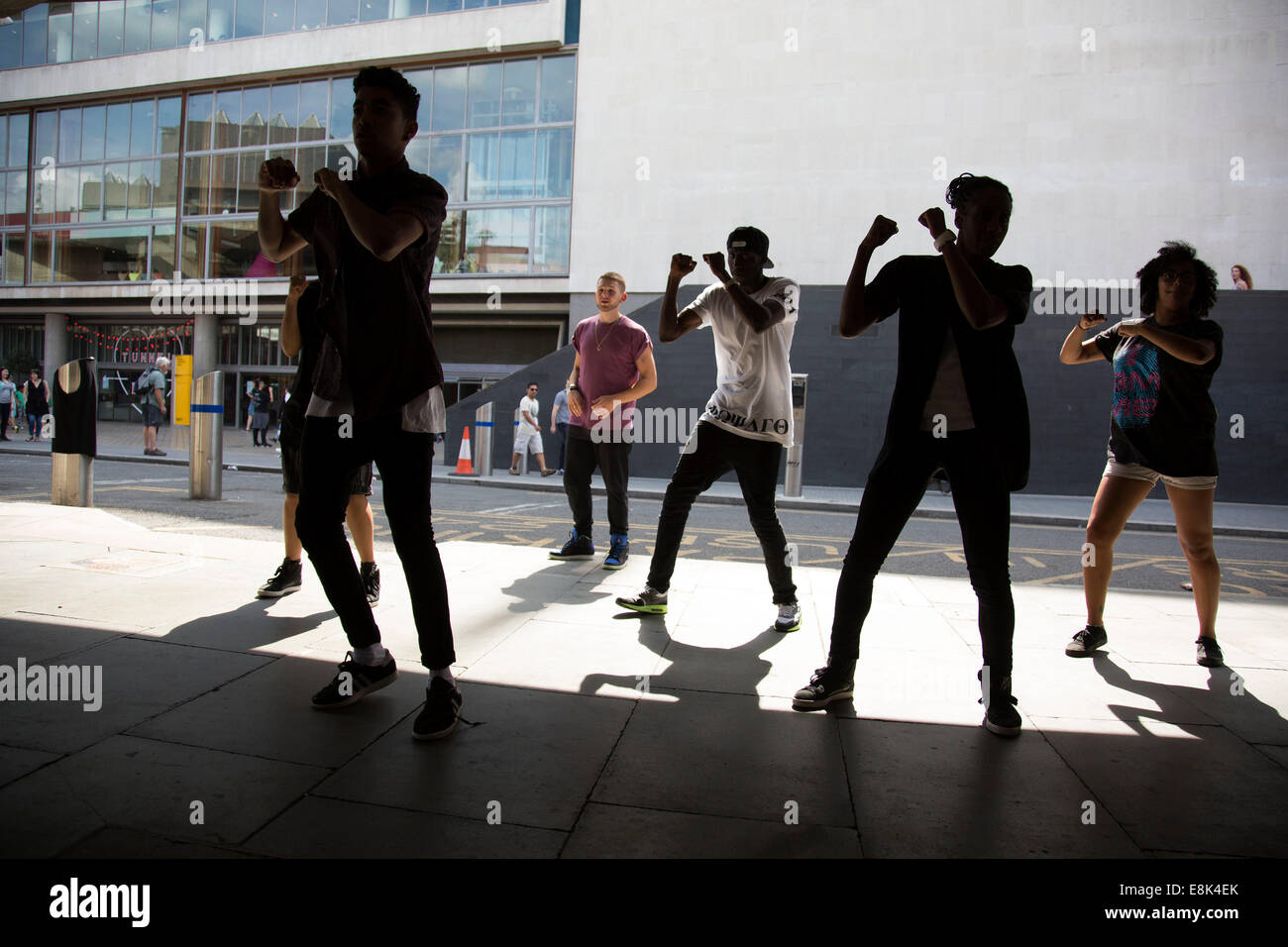 Street dance group practice their boxing themed routine outside the ...