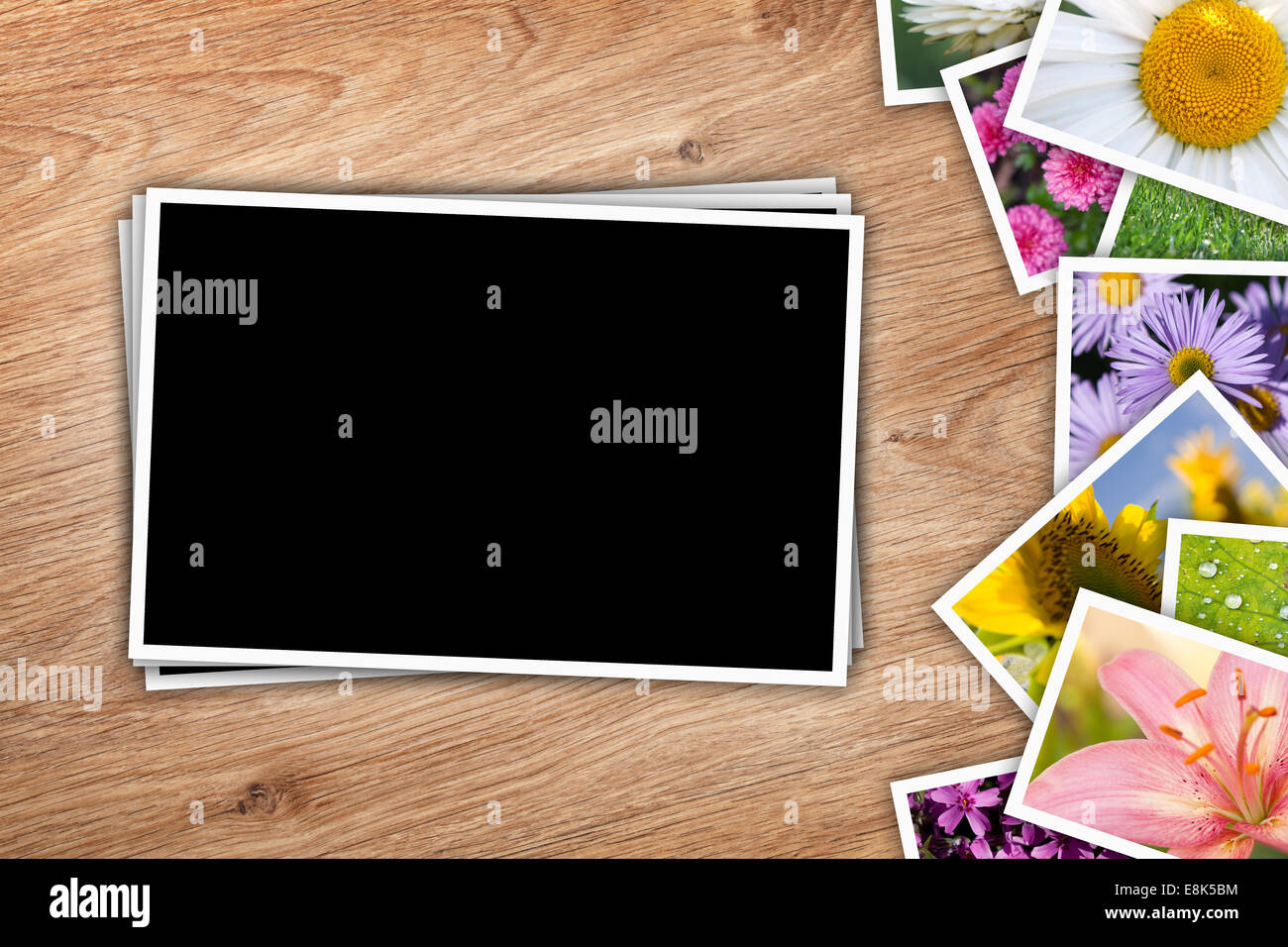 Stack of printed pictures collage on wooden table with copy space for ...