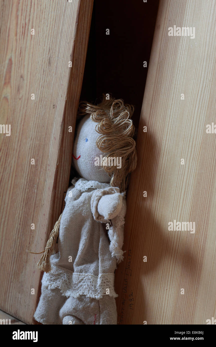 A rag doll is stuck in a wooden cabinet Stock Photo - Alamy