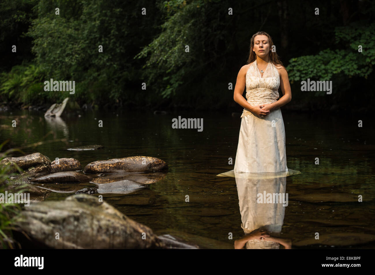 Trash the dress: a 'bride' wearing her wedding dress standing in a ...