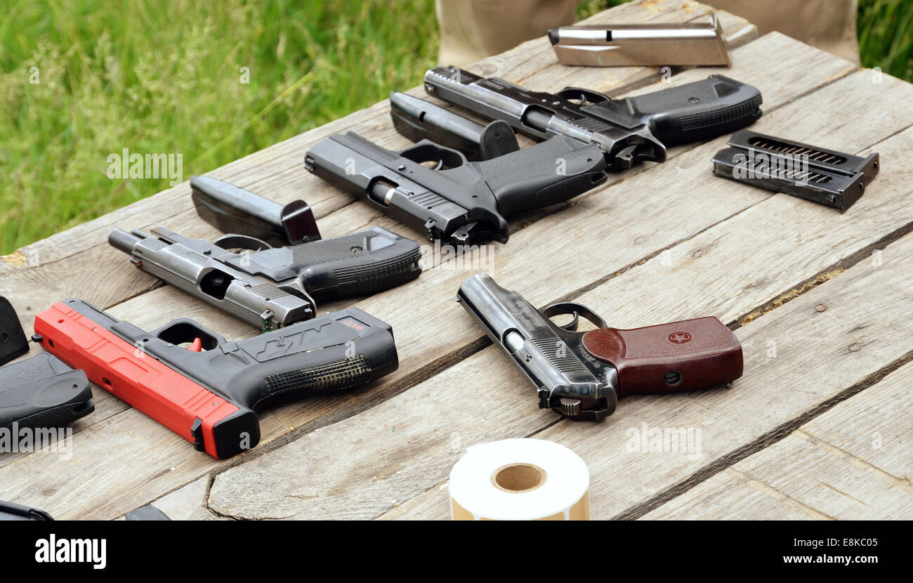 Portable guns on the table Stock Photo - Alamy