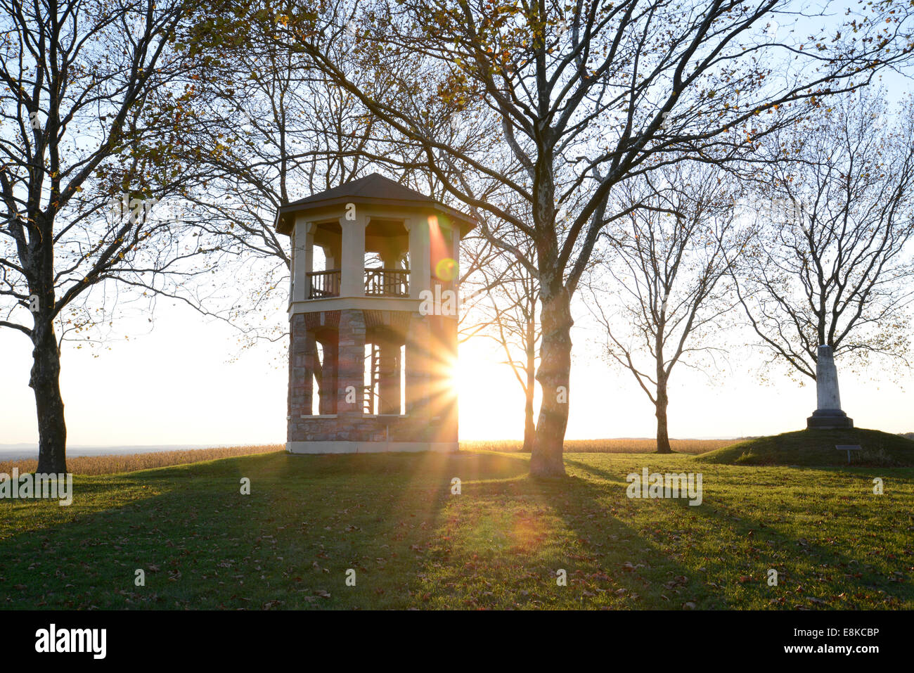 tower at sunset with sun shining around the building. there are several ...