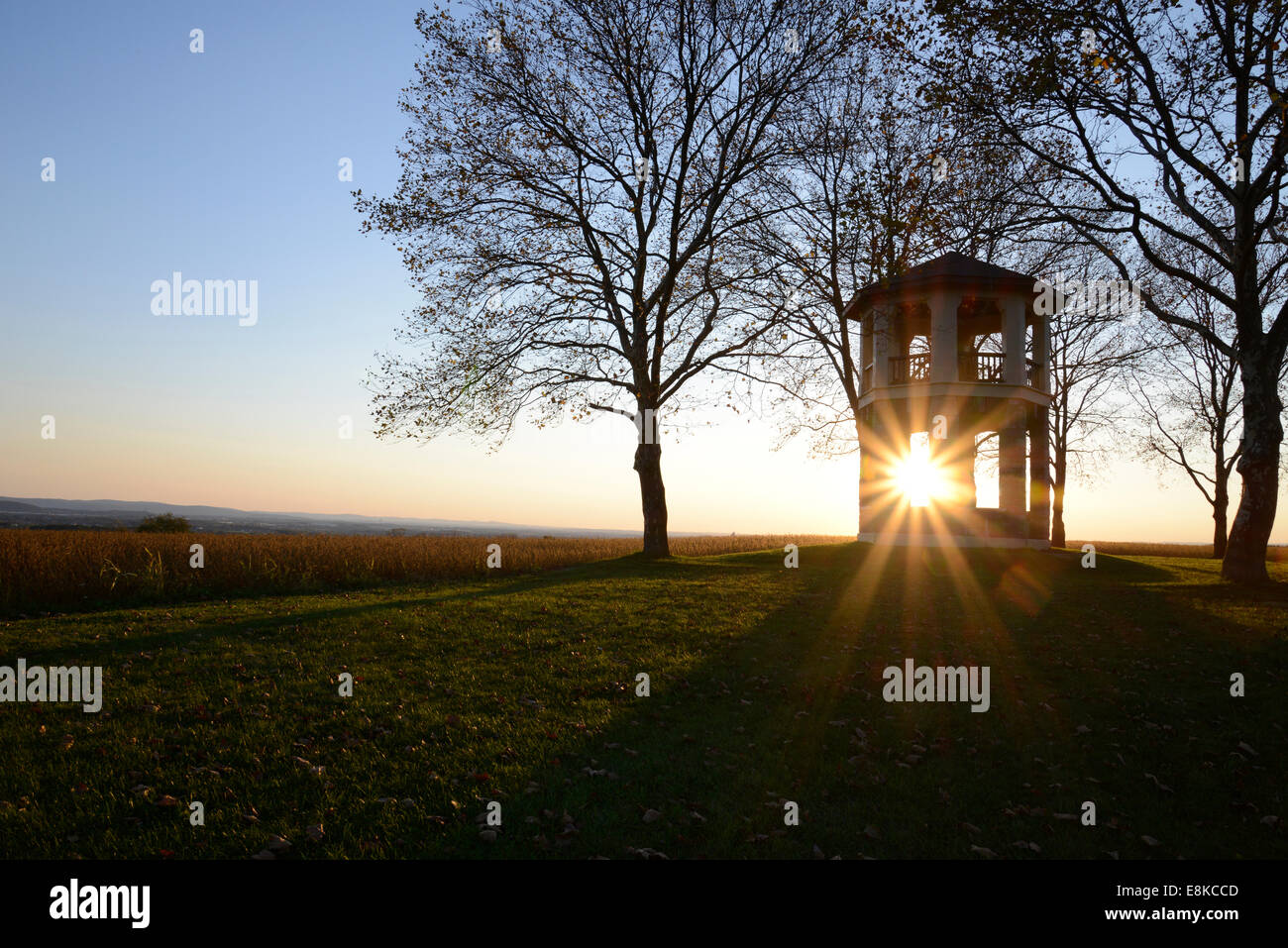 tower at sunset with sun shining around the building. there are several ...