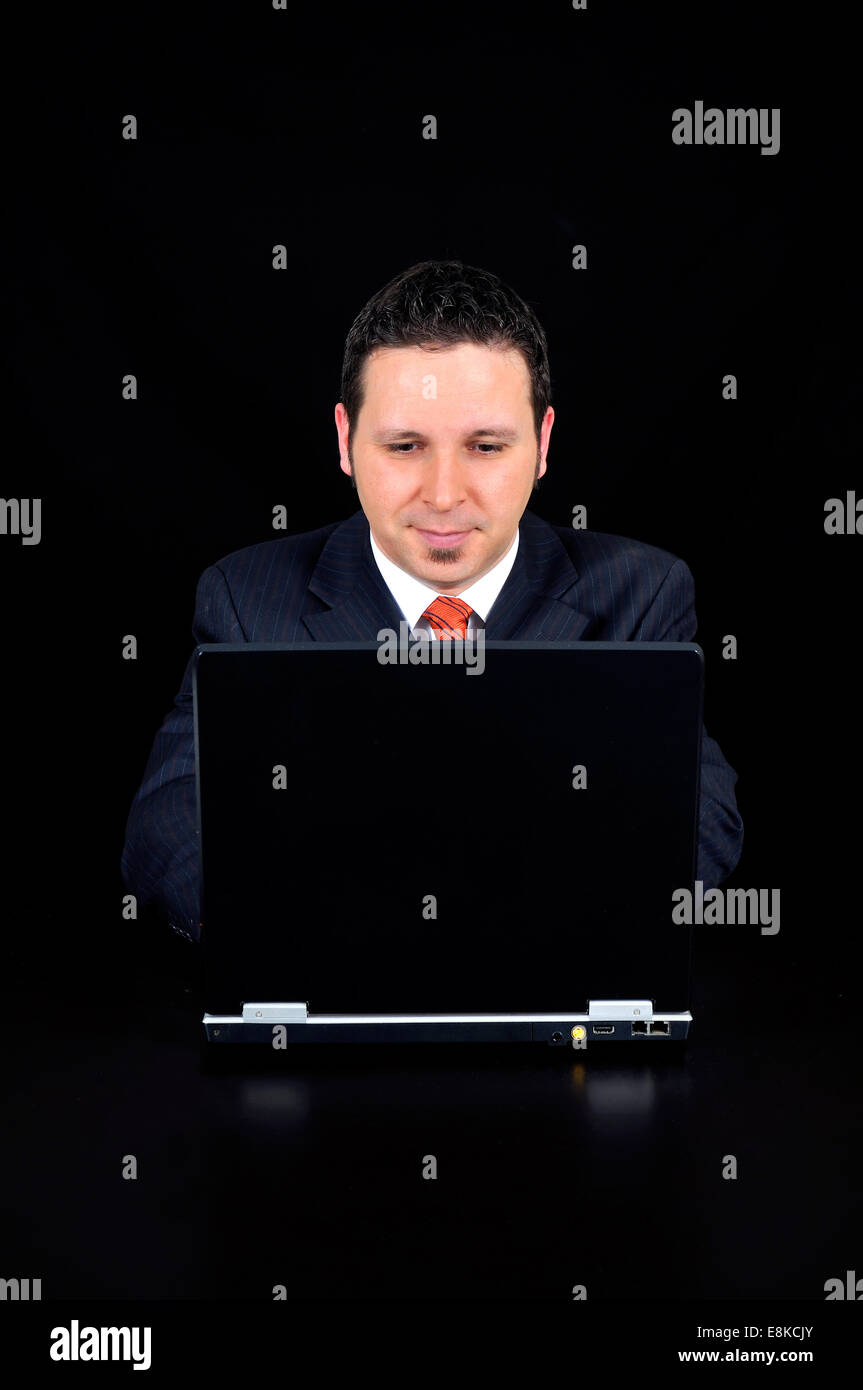Businessman is using the computer on the black background Stock Photo ...